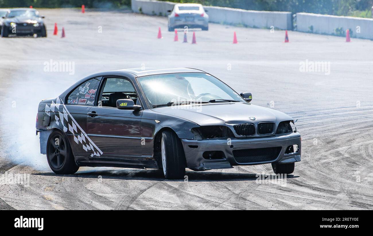 Car drifting auto racing event action with smoking tires - burning ...