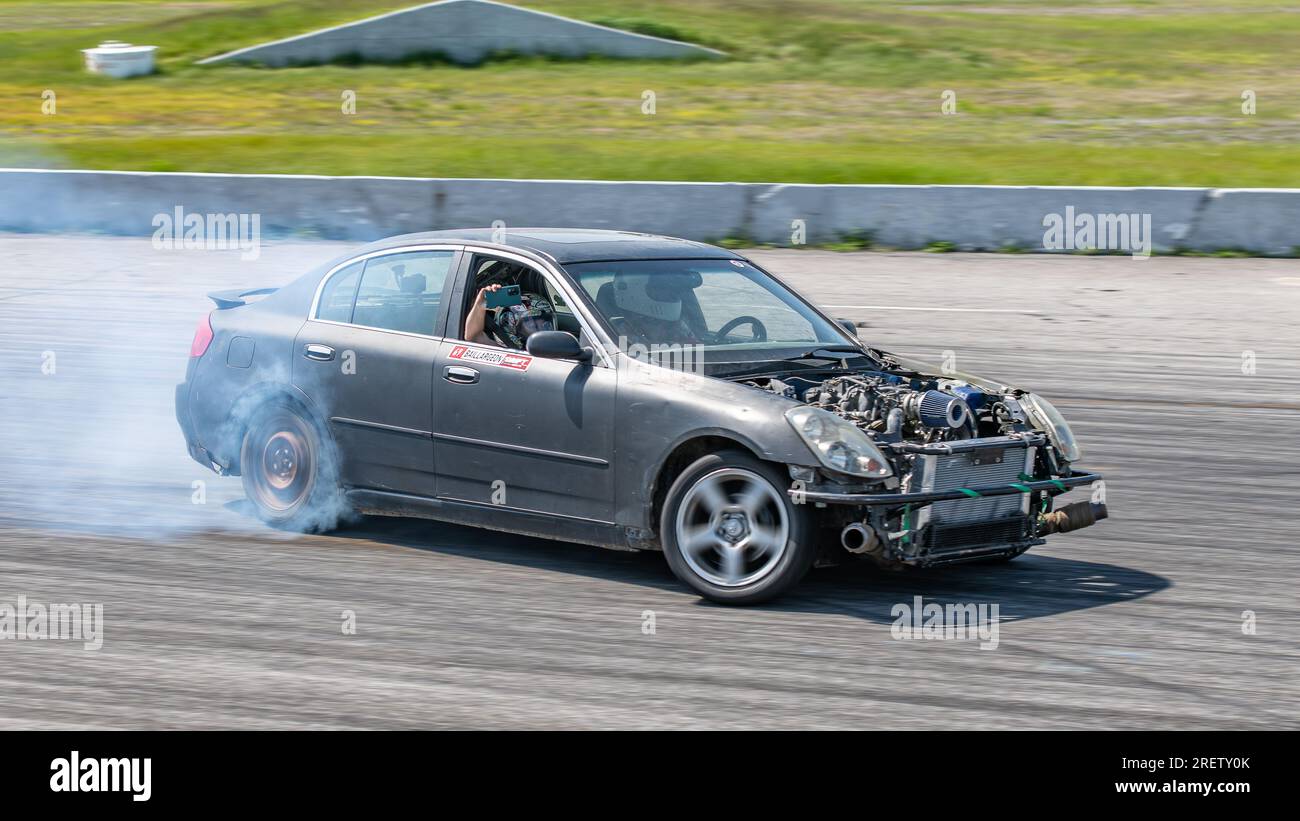 Car drifting auto racing event action with smoking tires - burning ...