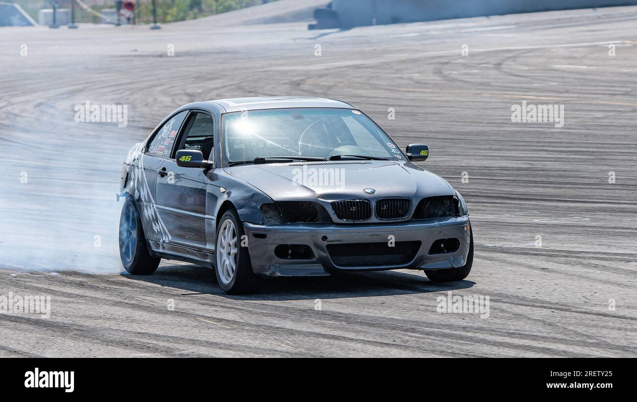 Car drifting auto racing event action with smoking tires - burning ...