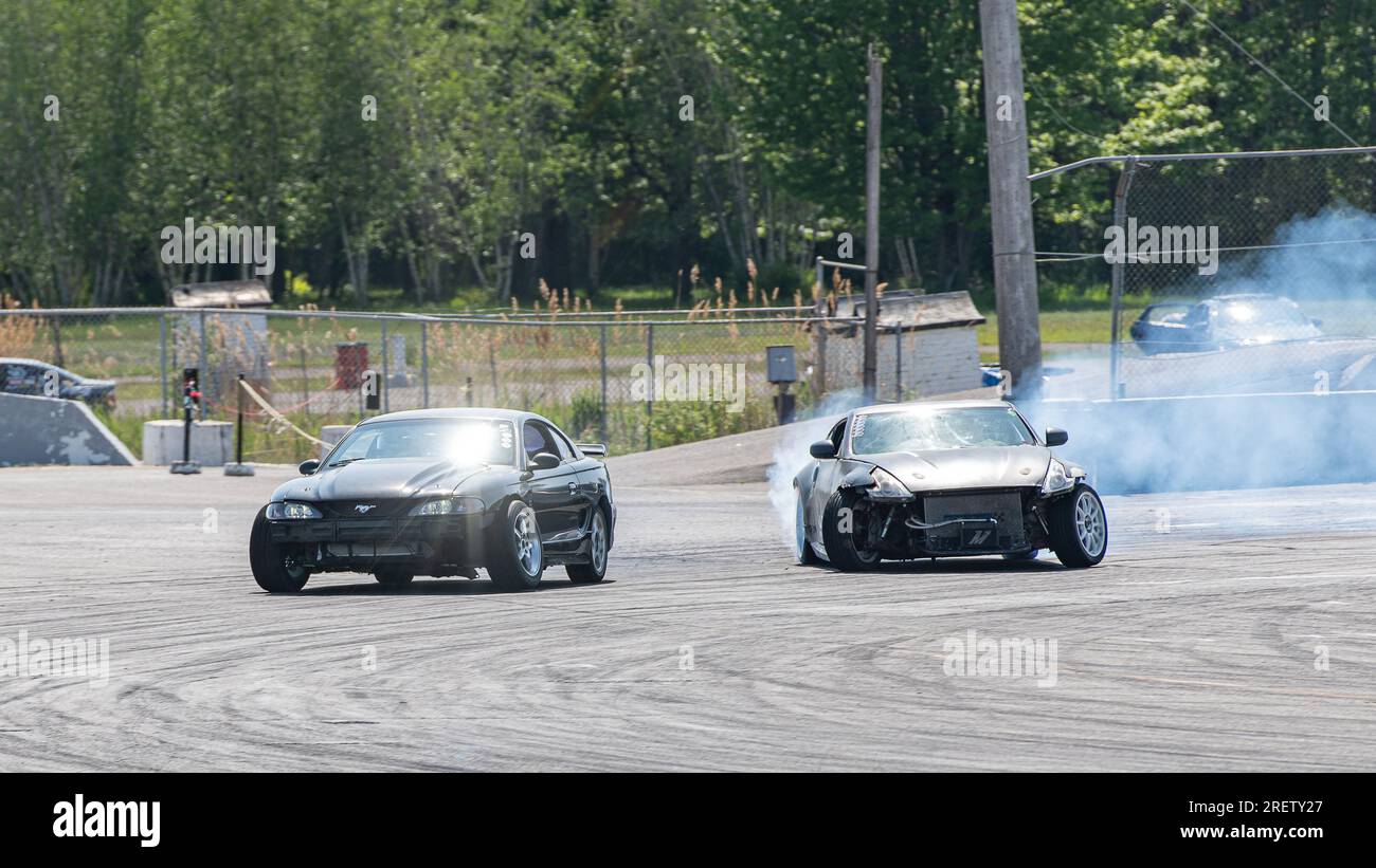 Car drifting auto racing event action with smoking tires - burning ...