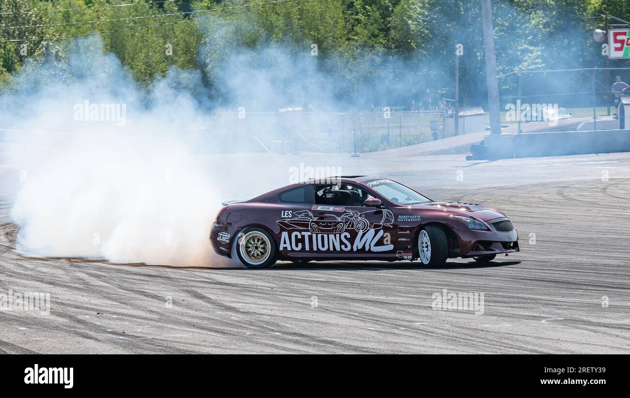 Car drifting auto racing event action with smoking tires - burning ...