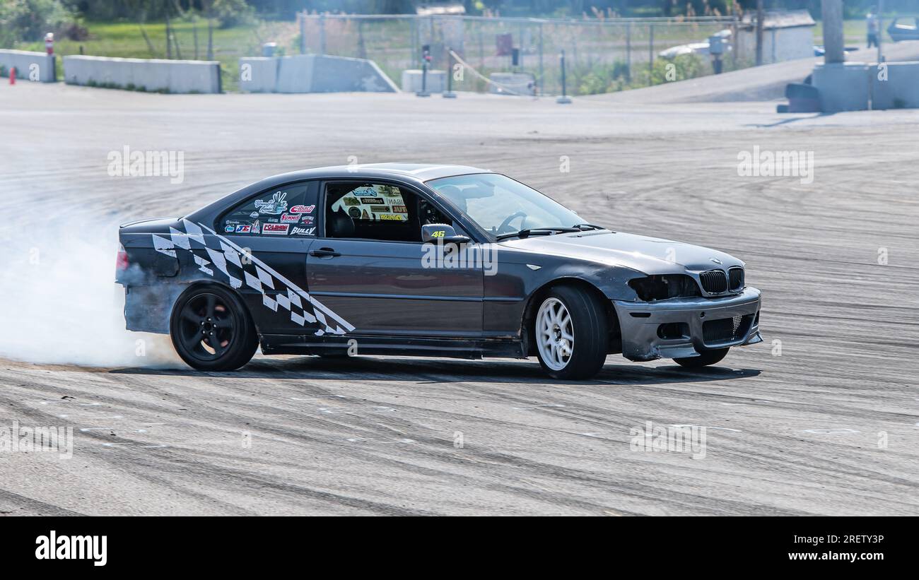 Car drifting auto racing event action with smoking tires - burning ...