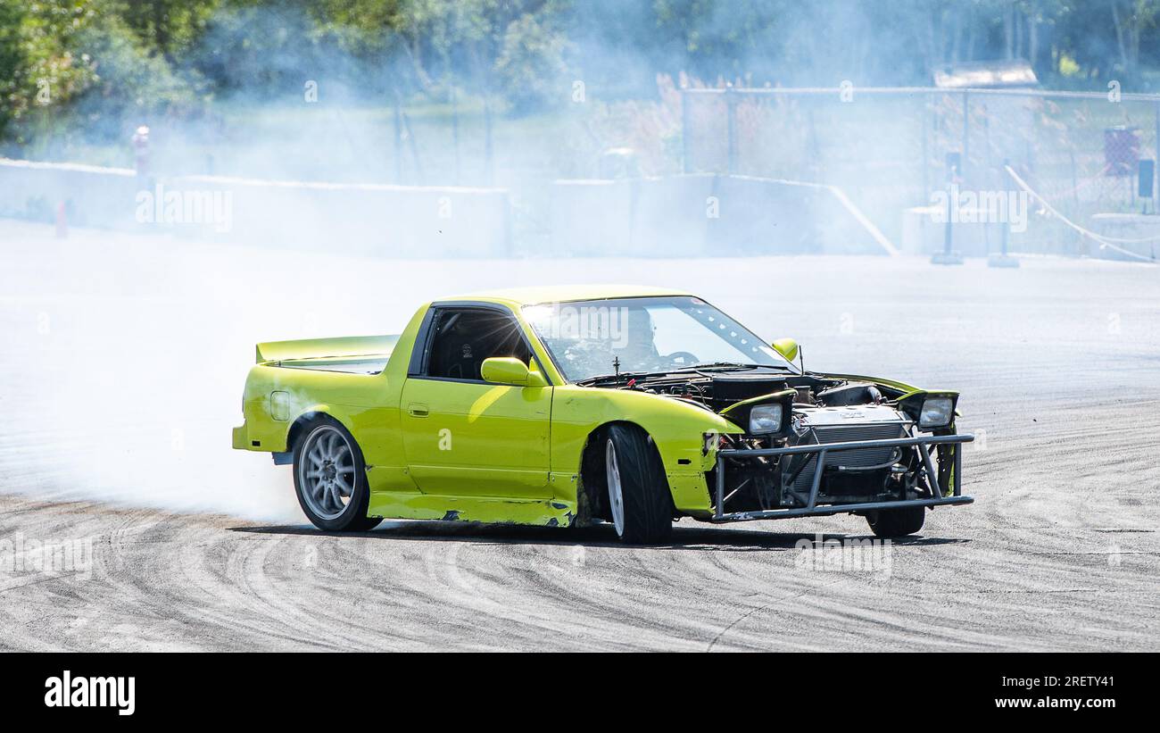 Car drifting auto racing event action with smoking tires - burning ...