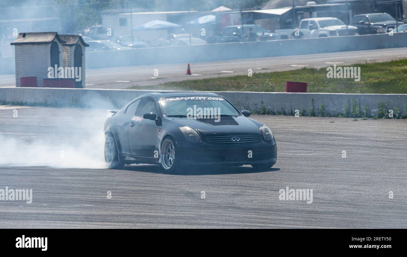 Car drifting auto racing event action with smoking tires - burning ...