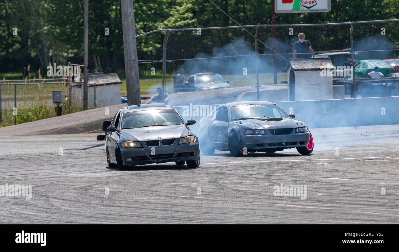 Car drifting auto racing event action with smoking tires - burning ...