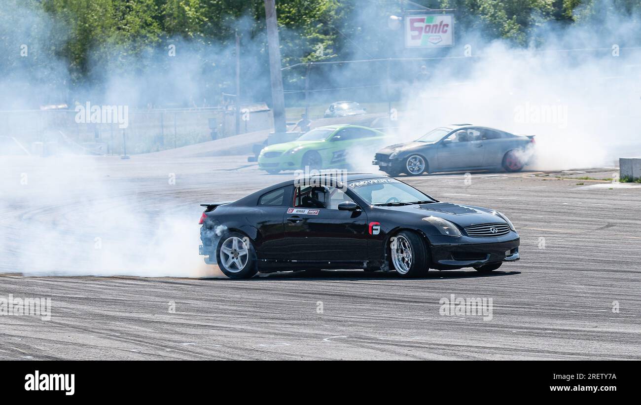 Car drifting auto racing event action with smoking tires - burning ...