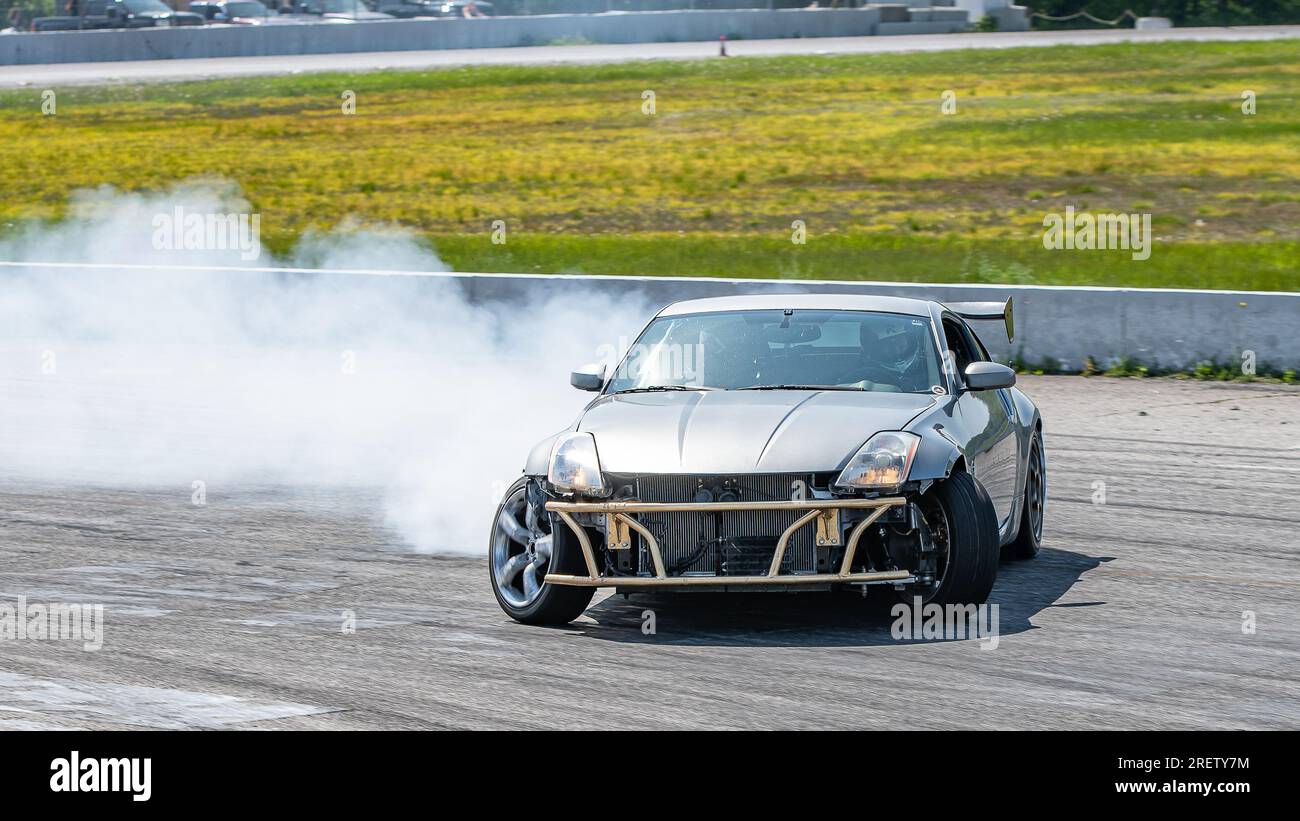Car drifting auto racing event action with smoking tires - burning ...