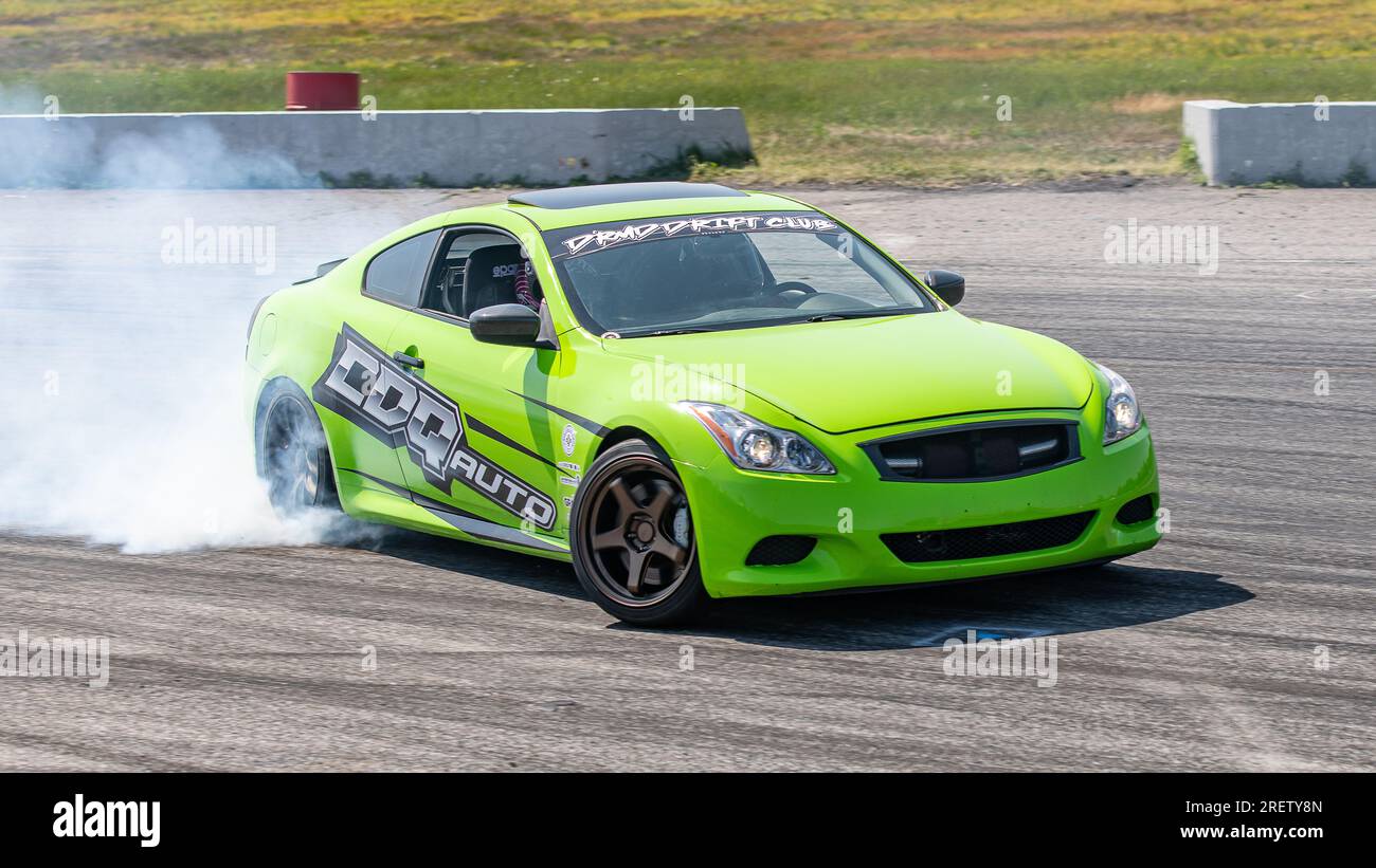 Car drifting auto racing event action with smoking tires - burning ...