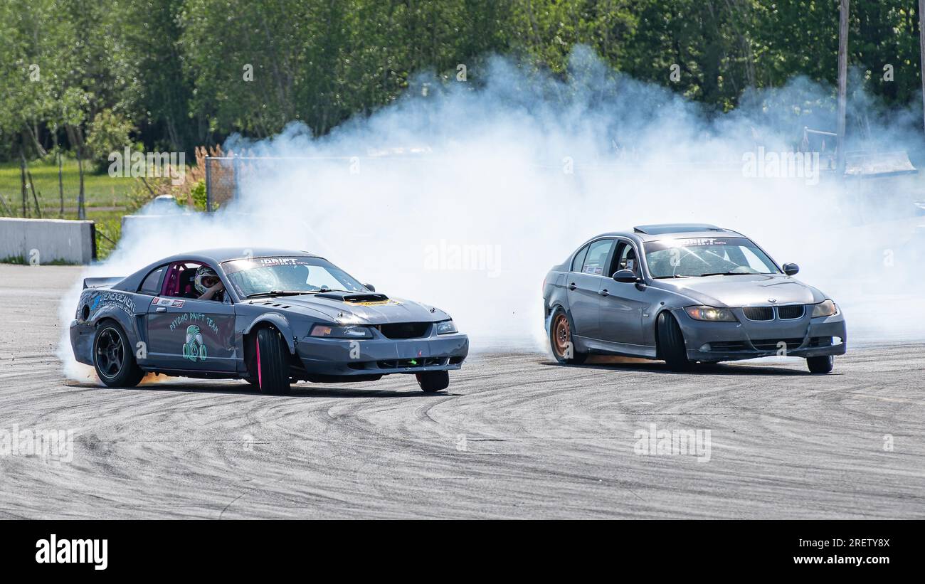 Car drifting auto racing event action with smoking tires - burning ...