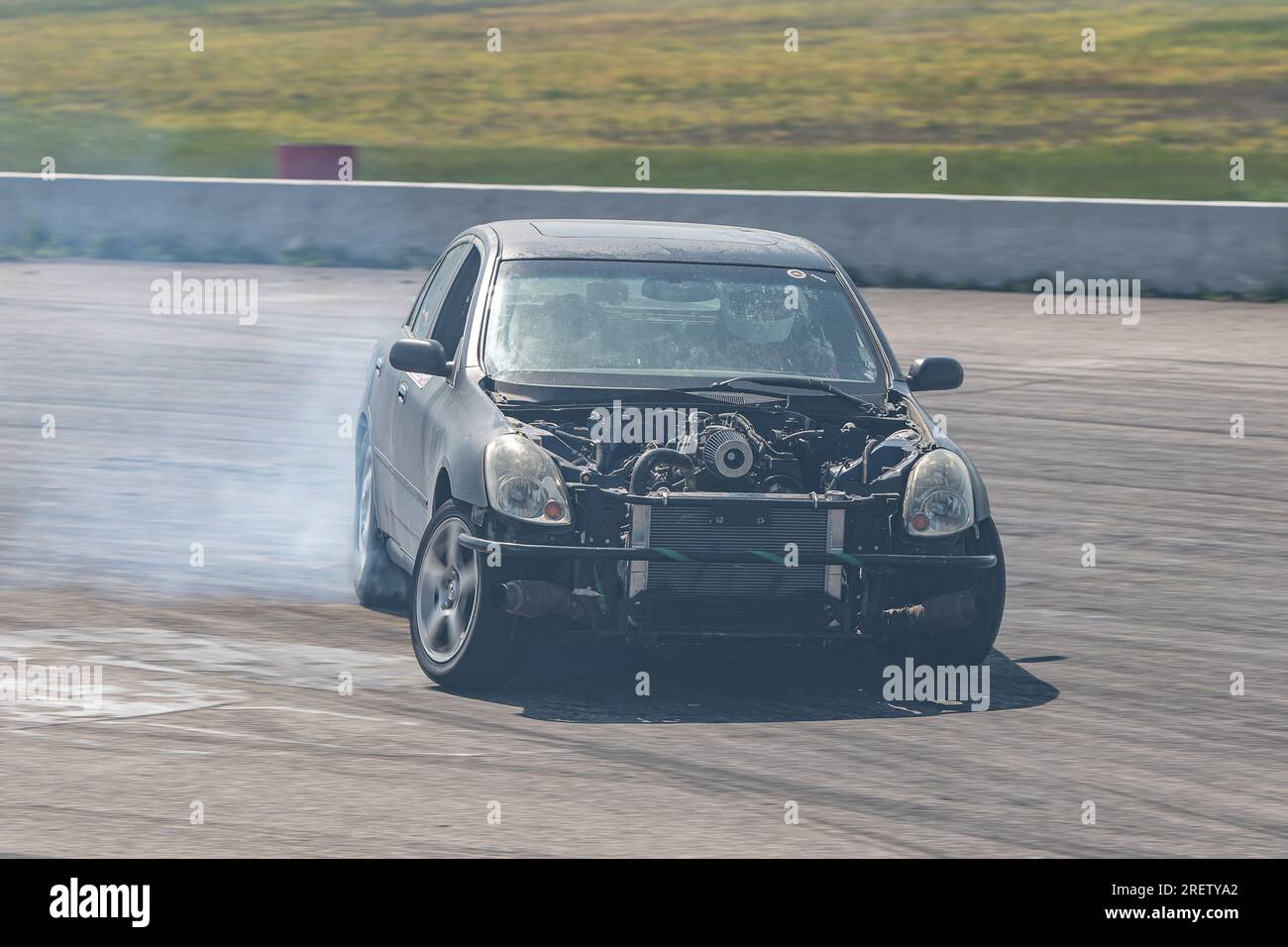 Car drifting auto racing event action with smoking tires - burning ...