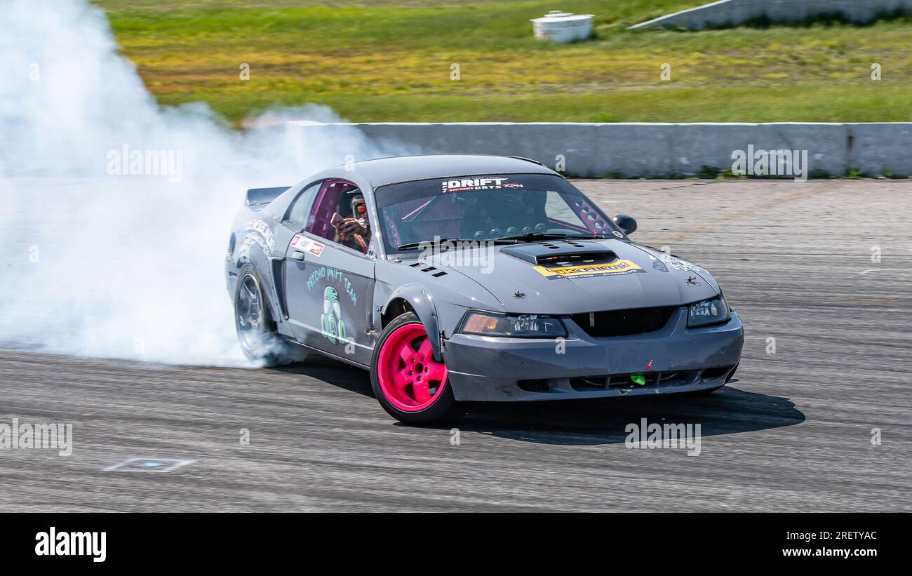 Car drifting auto racing event action with smoking tires - burning ...