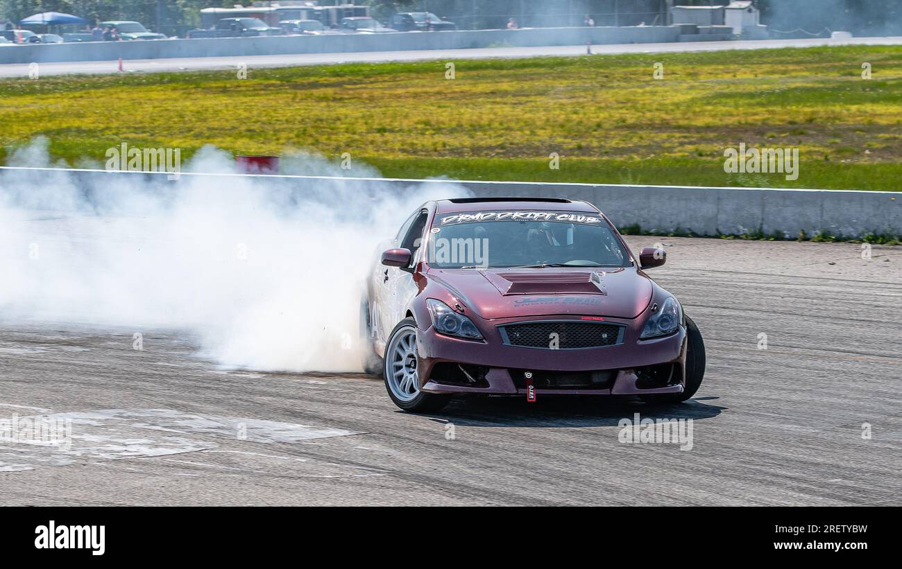 Car drifting auto racing event action with smoking tires - burning ...