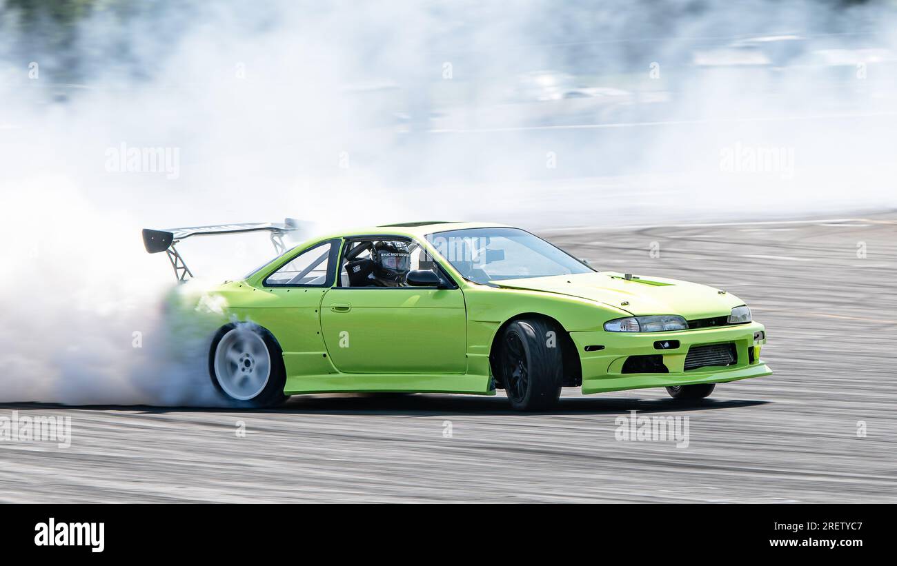 Car drifting auto racing event action with smoking tires - burning ...