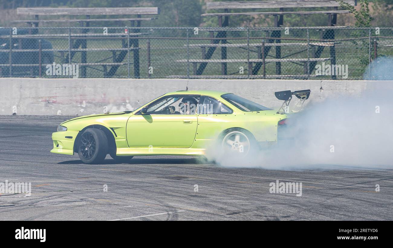 Car drifting auto racing event action with smoking tires - burning ...
