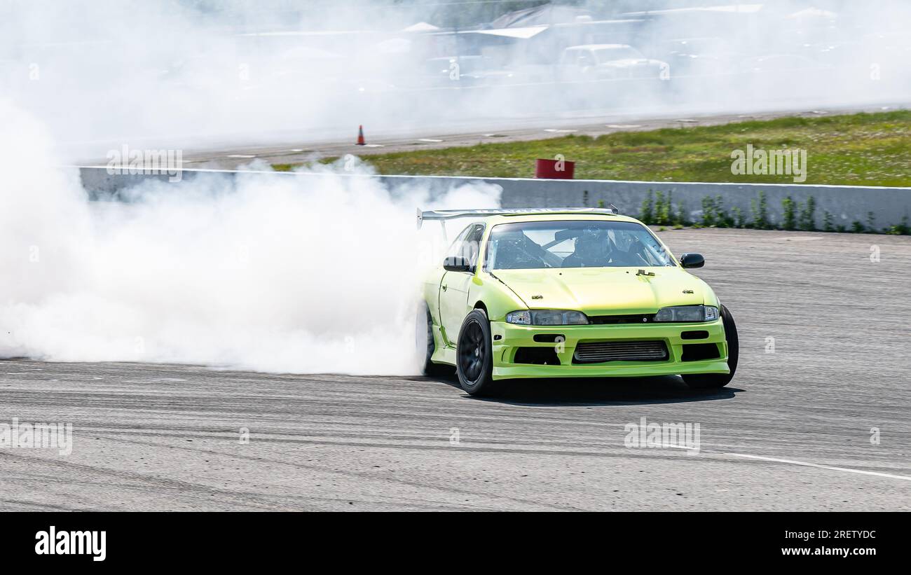 Car drifting auto racing event action with smoking tires - burning ...