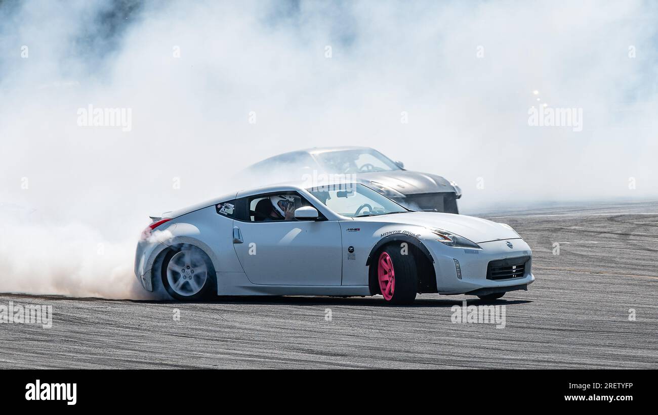 Car drifting auto racing event action with smoking tires - burning ...