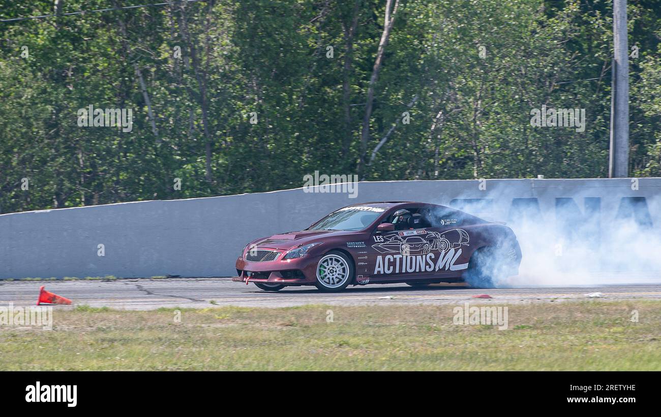 Car drifting auto racing event action with smoking tires - burning ...