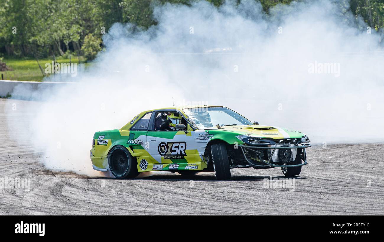 Car drifting auto racing event action with smoking tires - burning ...