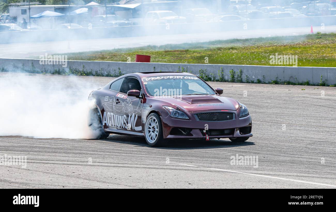 Car drifting auto racing event action with smoking tires - burning ...