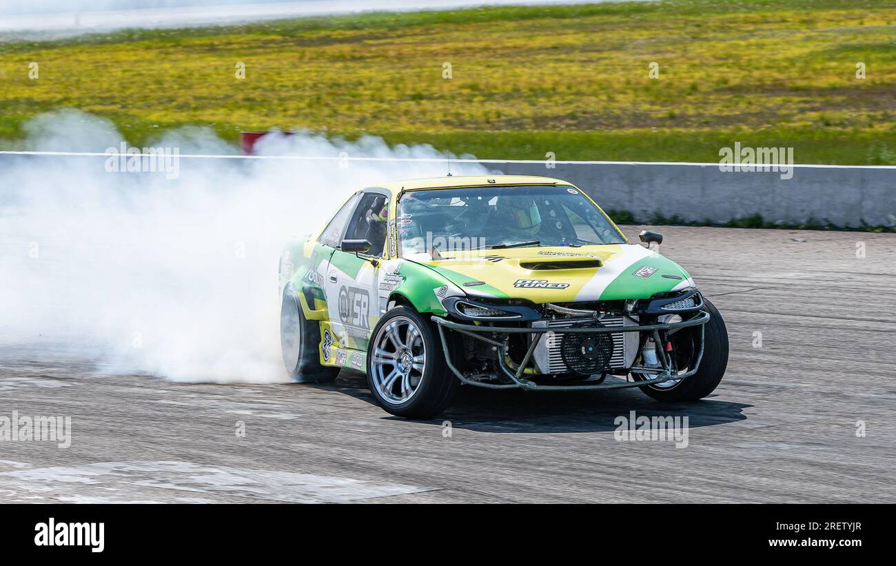 Car drifting auto racing event action with smoking tires - burning ...