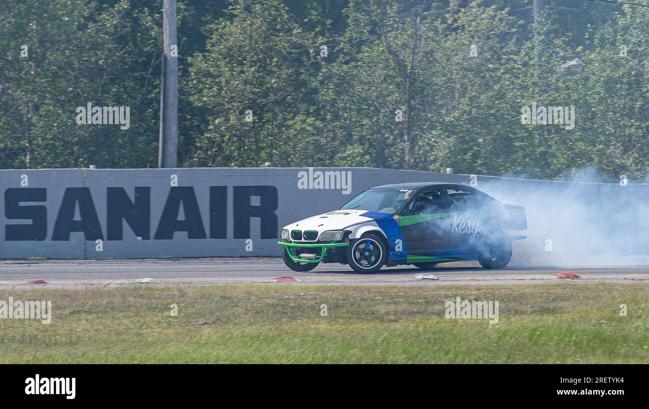 Car drifting auto racing event action with smoking tires - burning ...