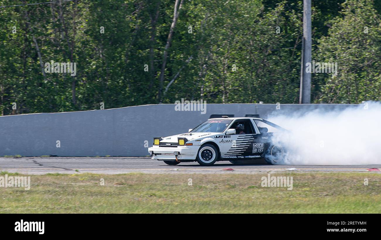 Car drifting auto racing event action with smoking tires - burning ...