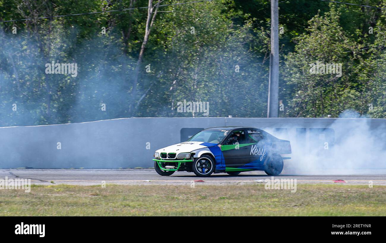 Car drifting auto racing event action with smoking tires - burning ...