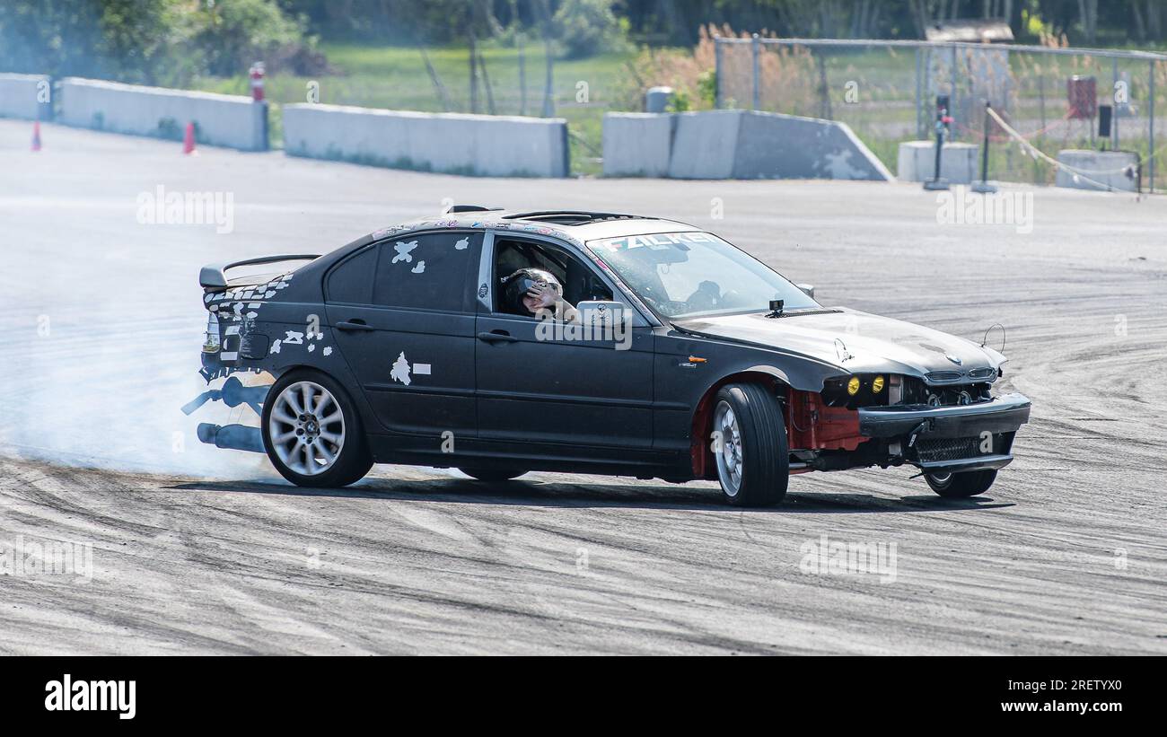 Car drifting auto racing event action with smoking tires - burning ...