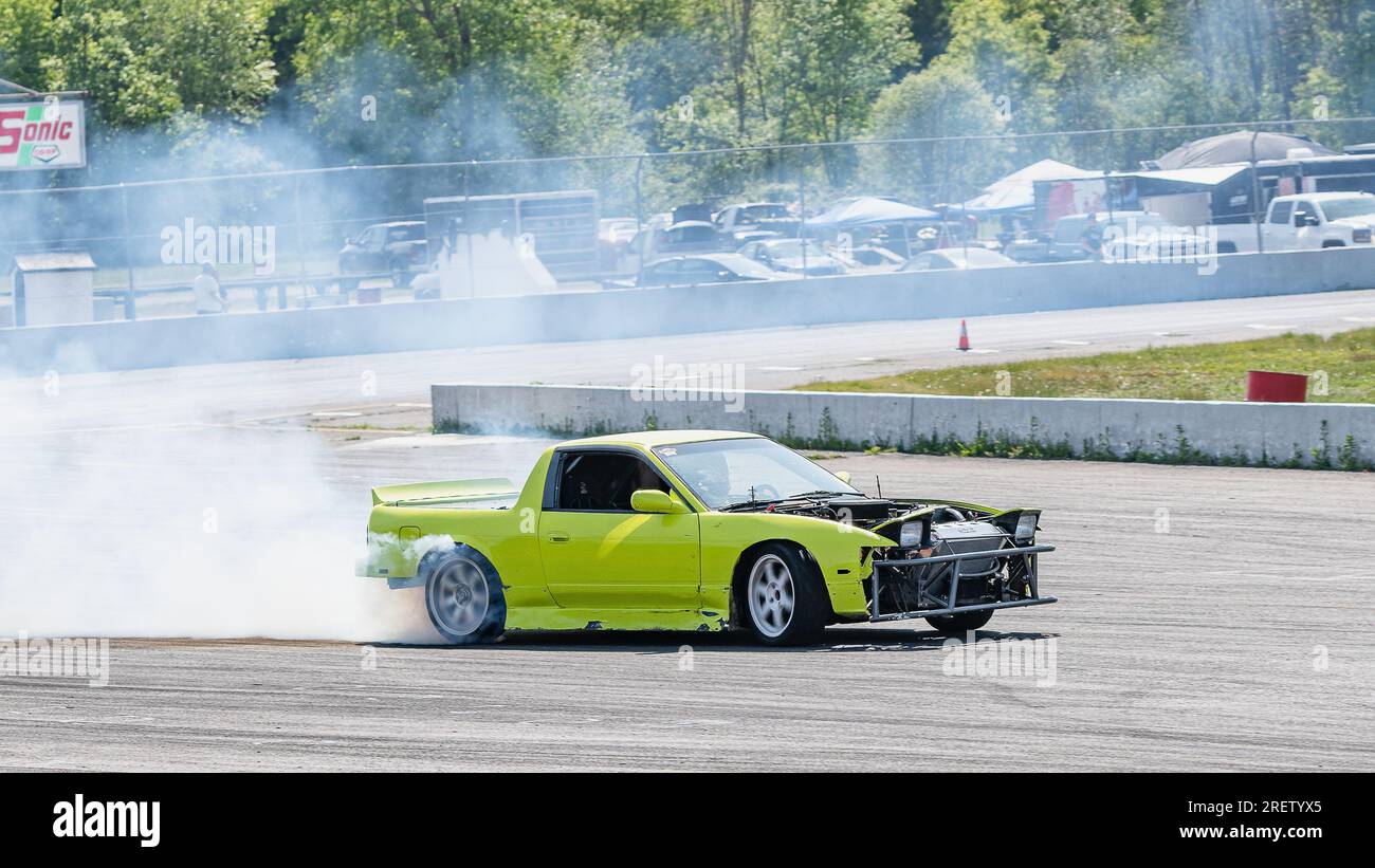 Car drifting auto racing event action with smoking tires - burning ...