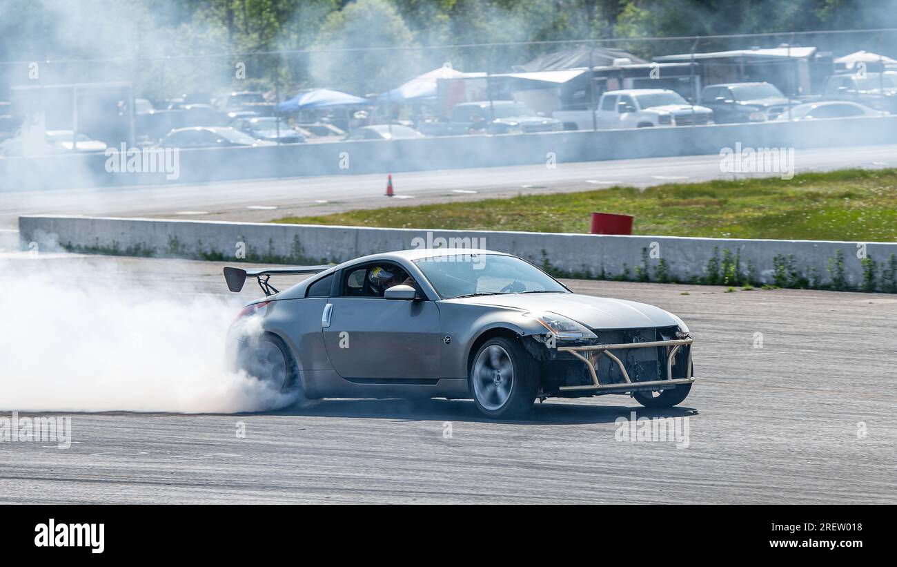 Car drifting auto racing event action with smoking tires - burning ...