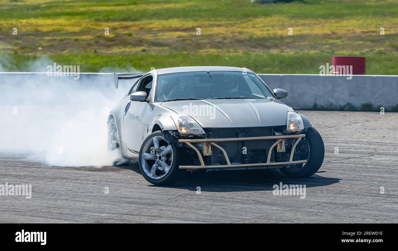 Car drifting auto racing event action with smoking tires - burning ...