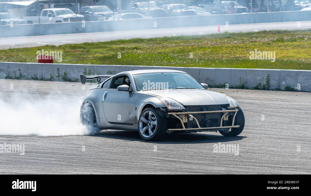 Car drifting auto racing event action with smoking tires - burning ...