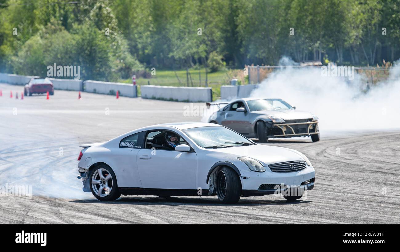 Car drifting auto racing event action with smoking tires - burning ...