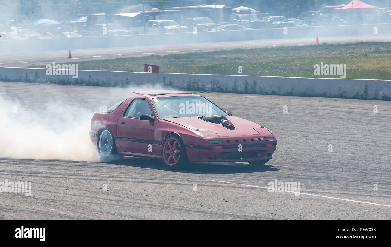 Car drifting auto racing event action with smoking tires - burning ...