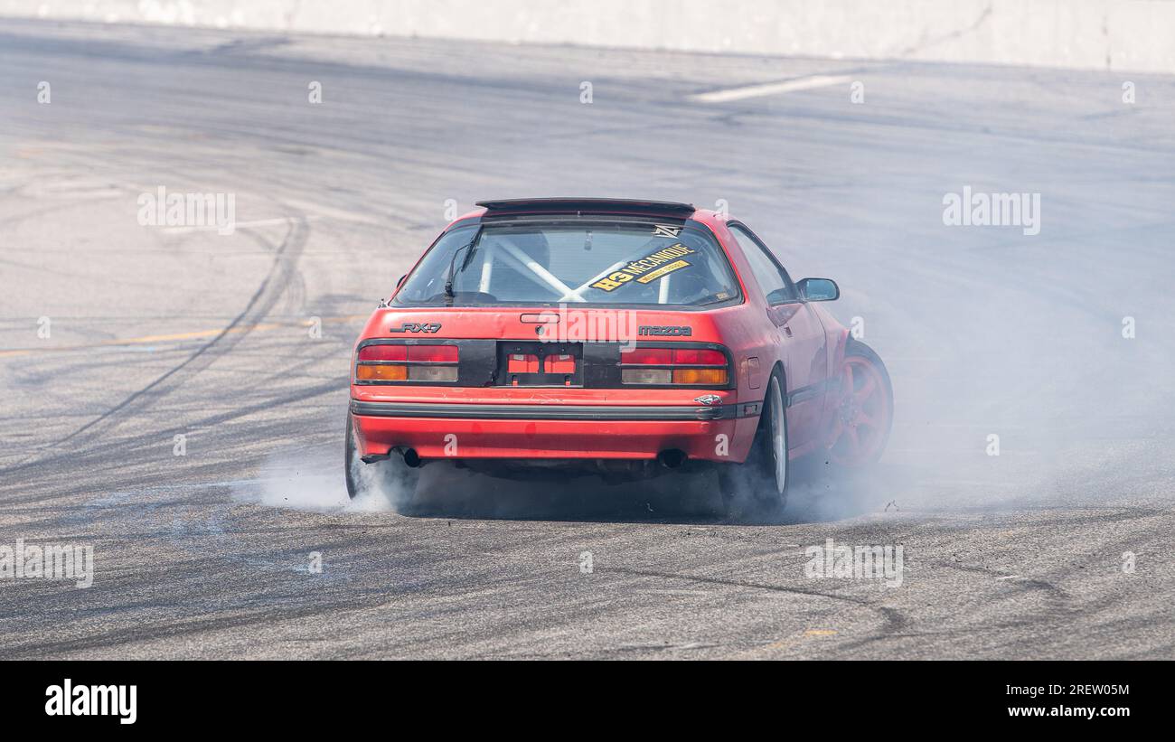 Car drifting auto racing event action with smoking tires - burning ...