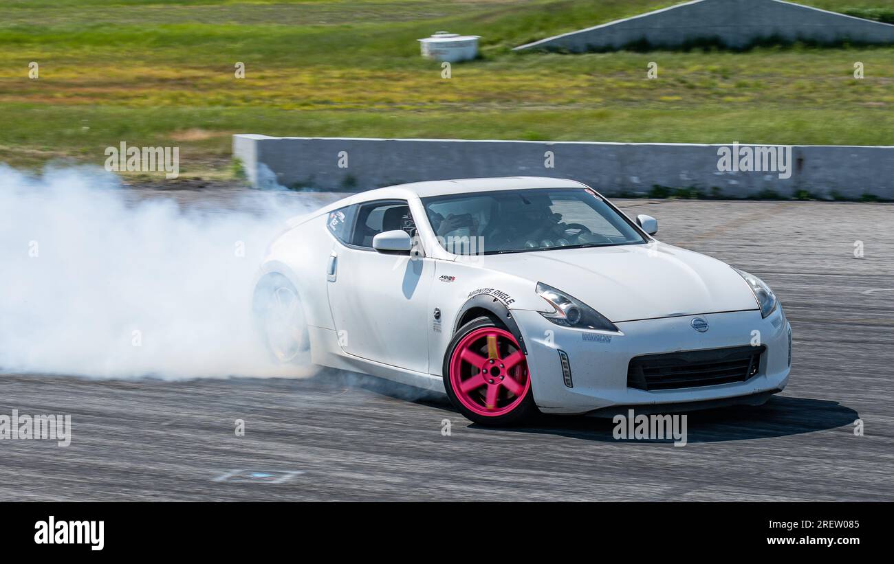 Car drifting auto racing event action with smoking tires - burning ...