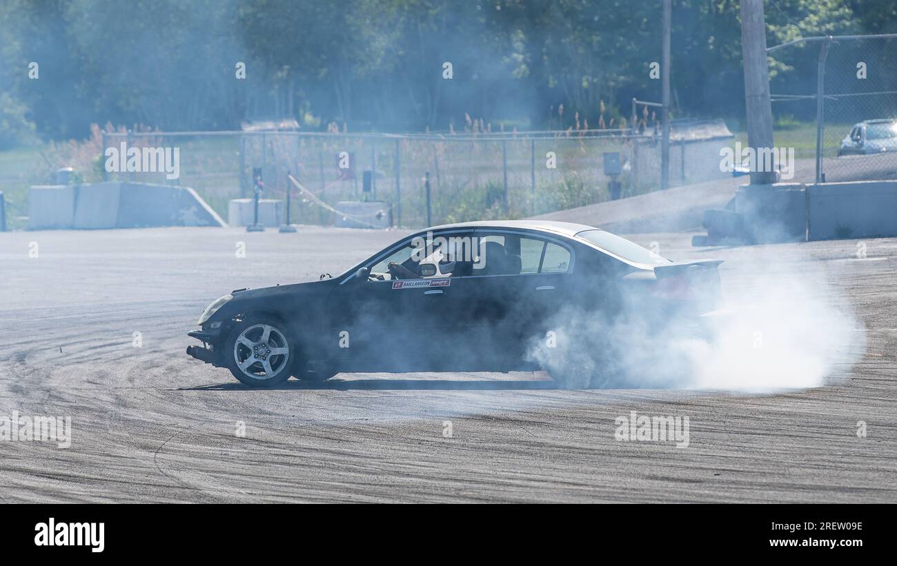 Car drifting auto racing event action with smoking tires - burning ...