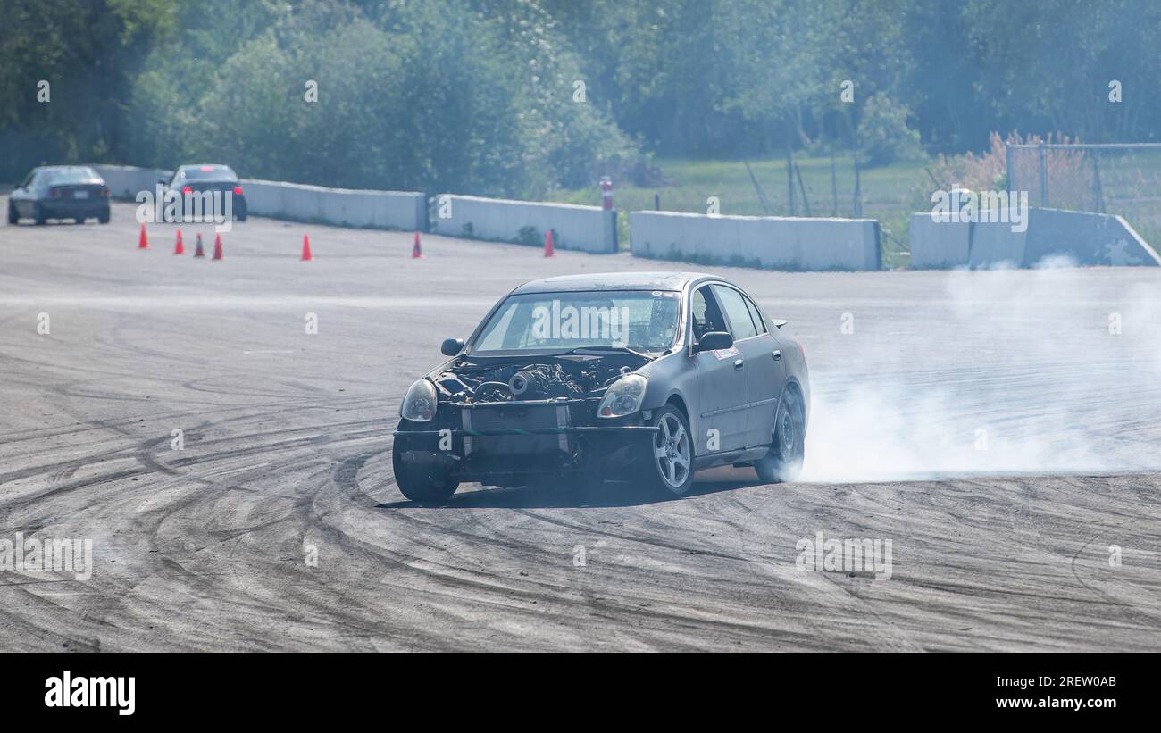 Car drifting auto racing event action with smoking tires - burning ...