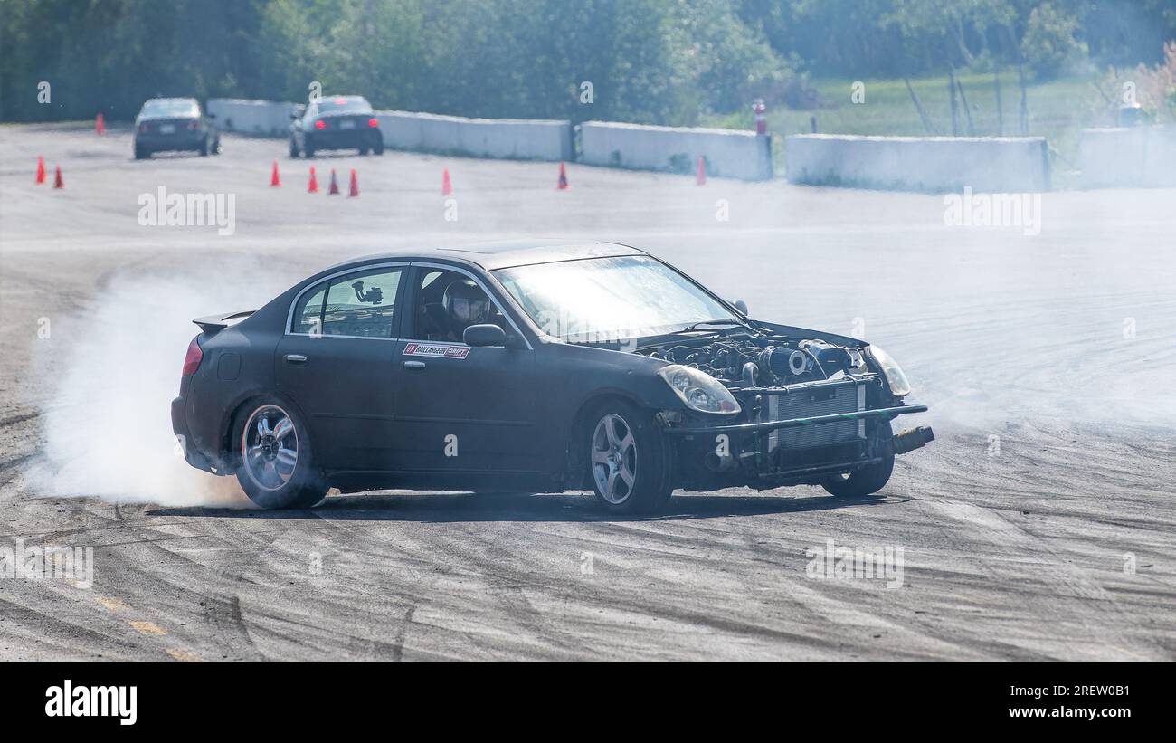 Car drifting auto racing event action with smoking tires - burning ...