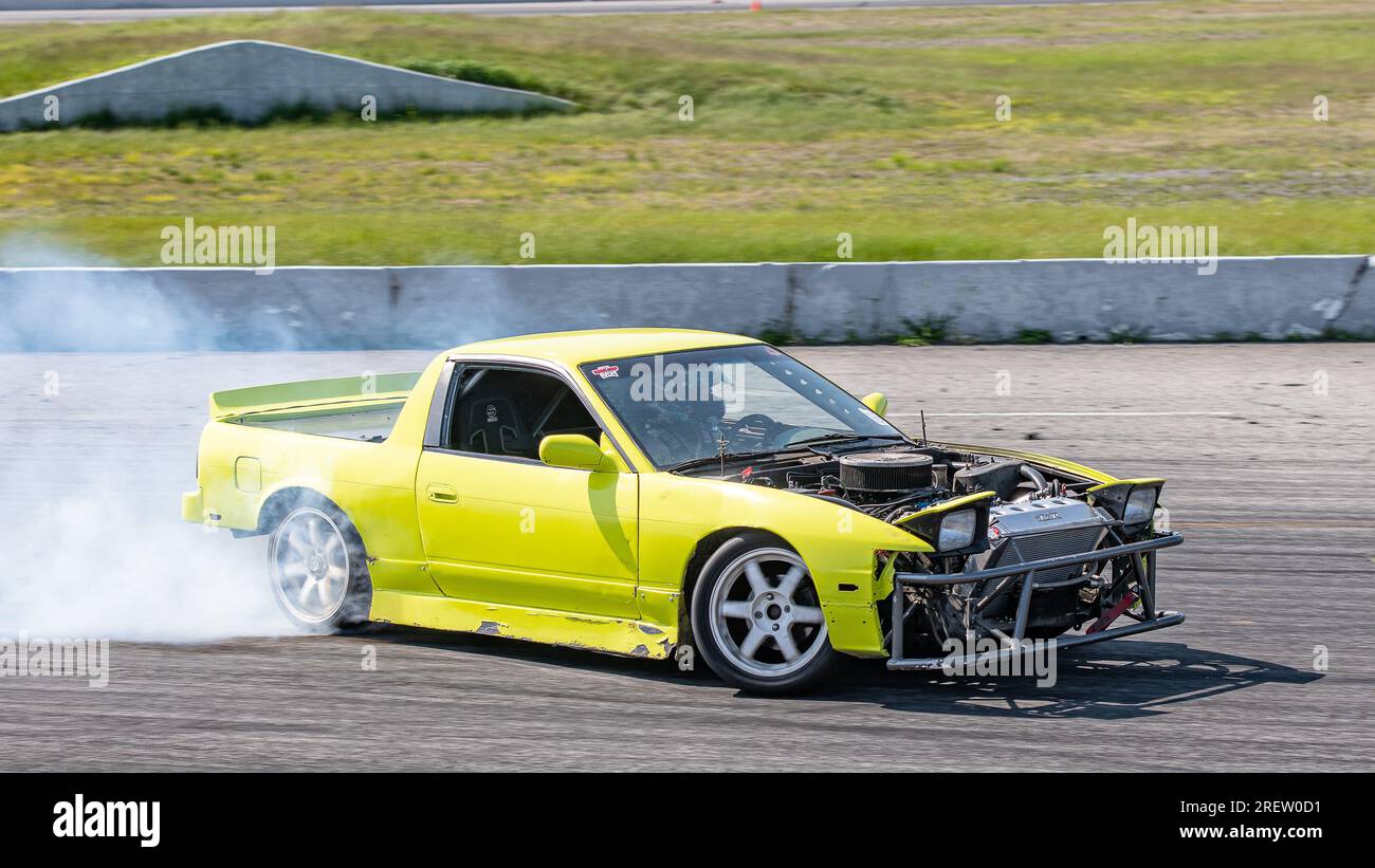 Car drifting auto racing event action with smoking tires - burning ...