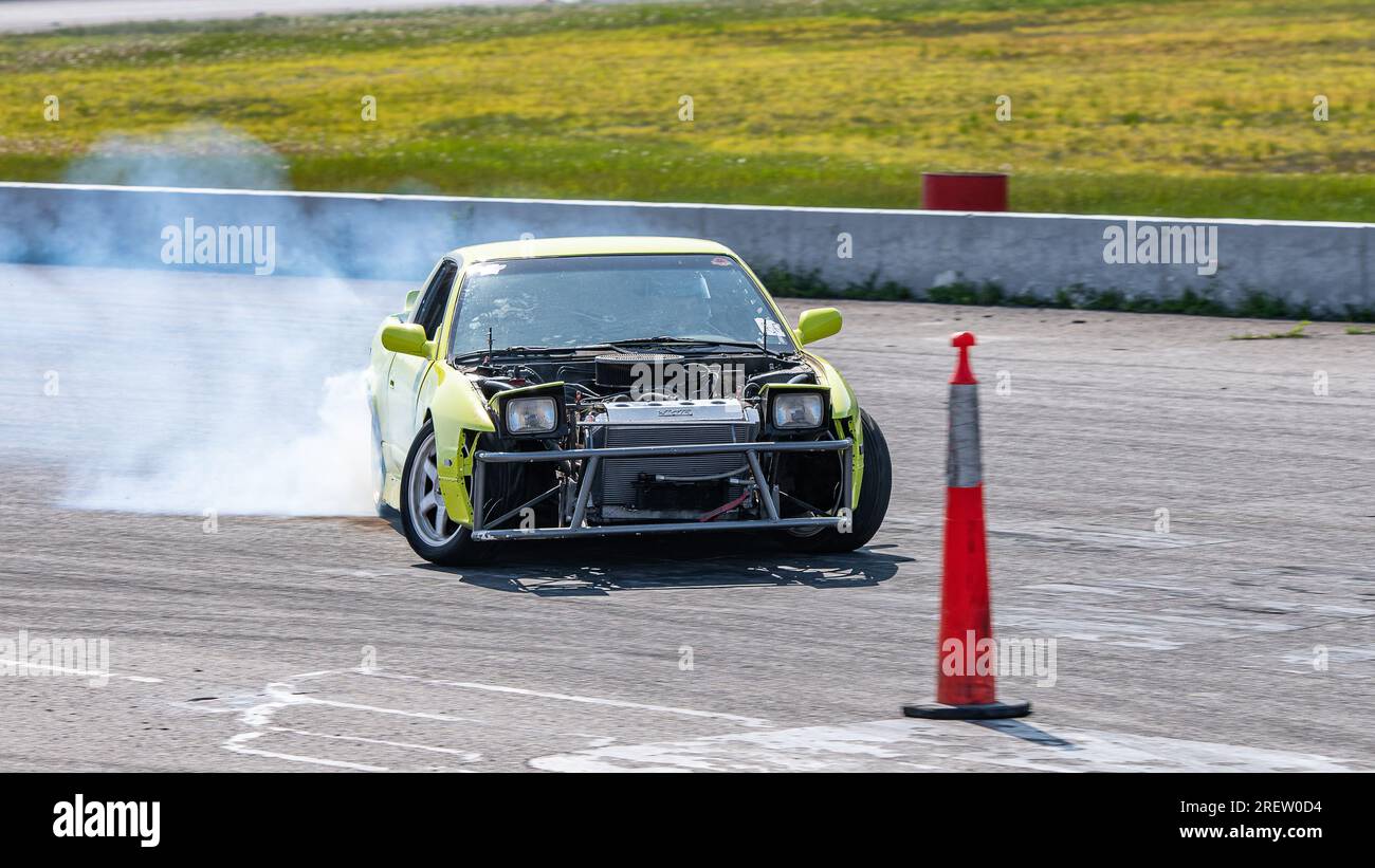Car drifting auto racing event action with smoking tires - burning ...