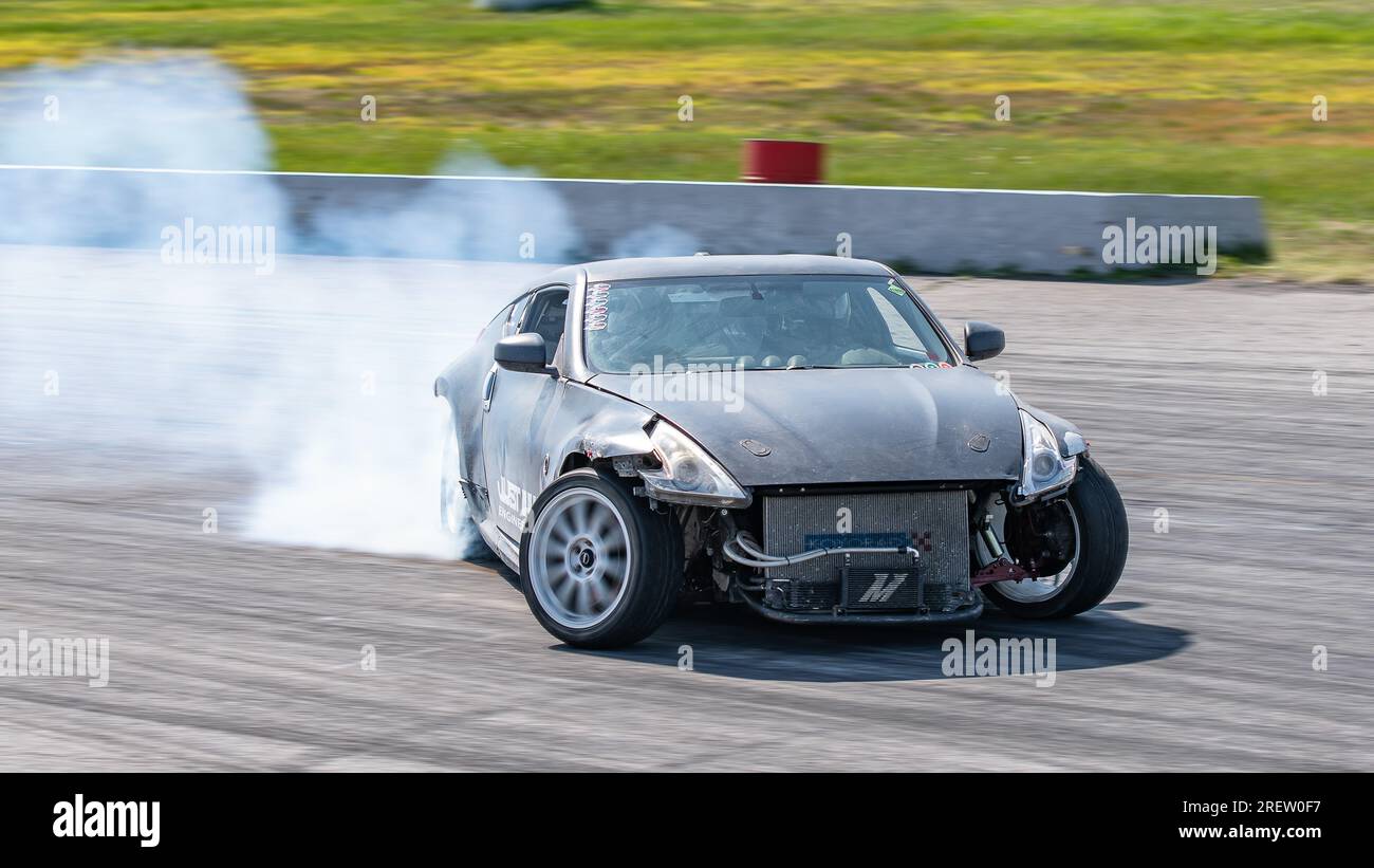 Car drifting auto racing event action with smoking tires - burning ...