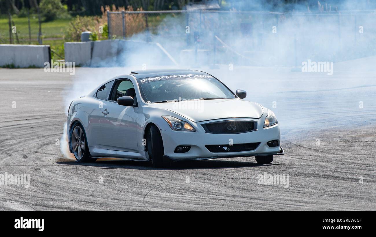 Car drifting auto racing event action with smoking tires - burning ...