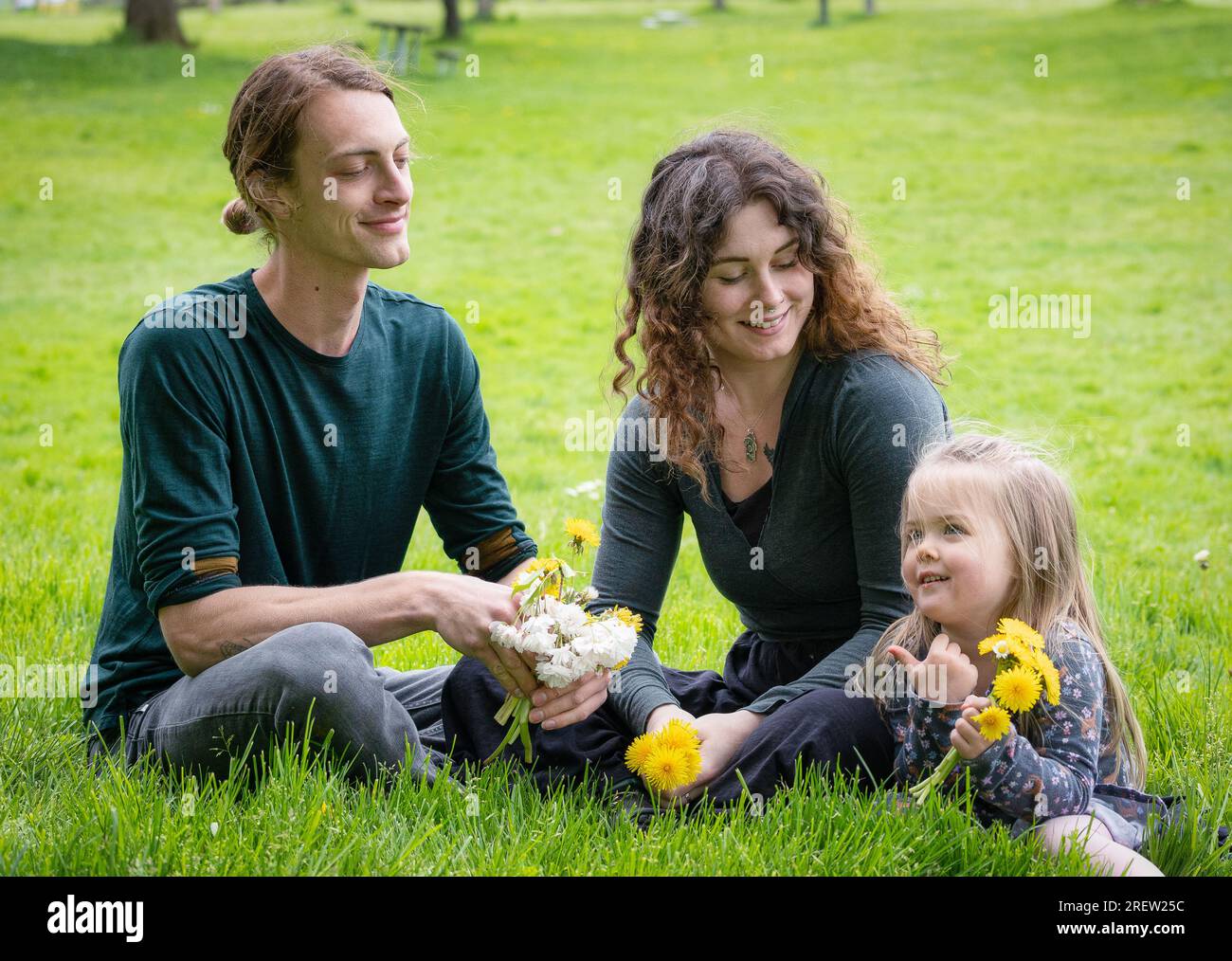 A happy family plays with flowers in a park Stock Photo - Alamy
