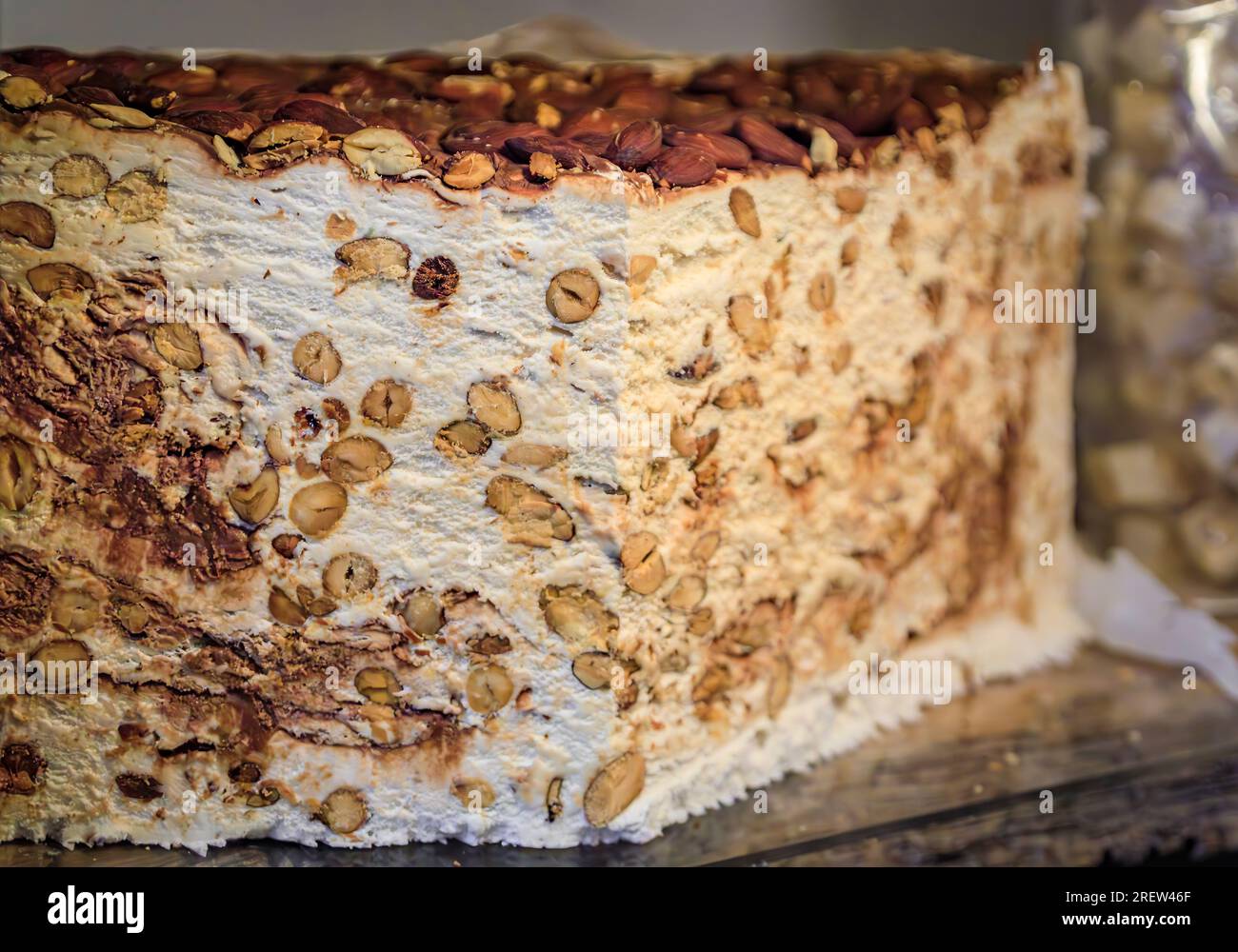 Block of fresh classic white nougat with almonds, hazelnut and honey at ...