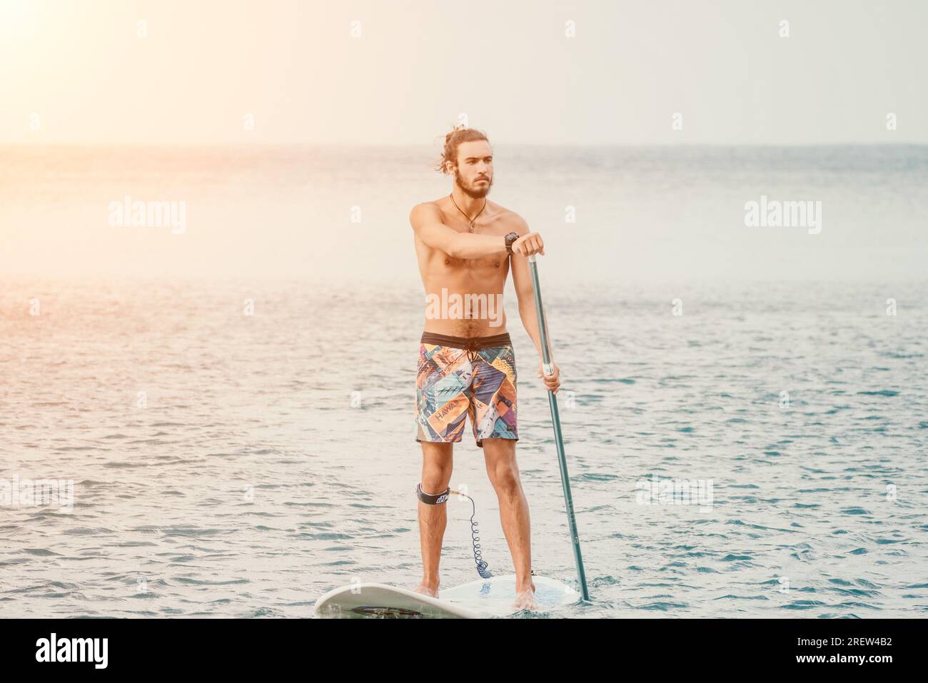 Sea man sup. Asian athlete man swimming in sea and paddleboarding at ...