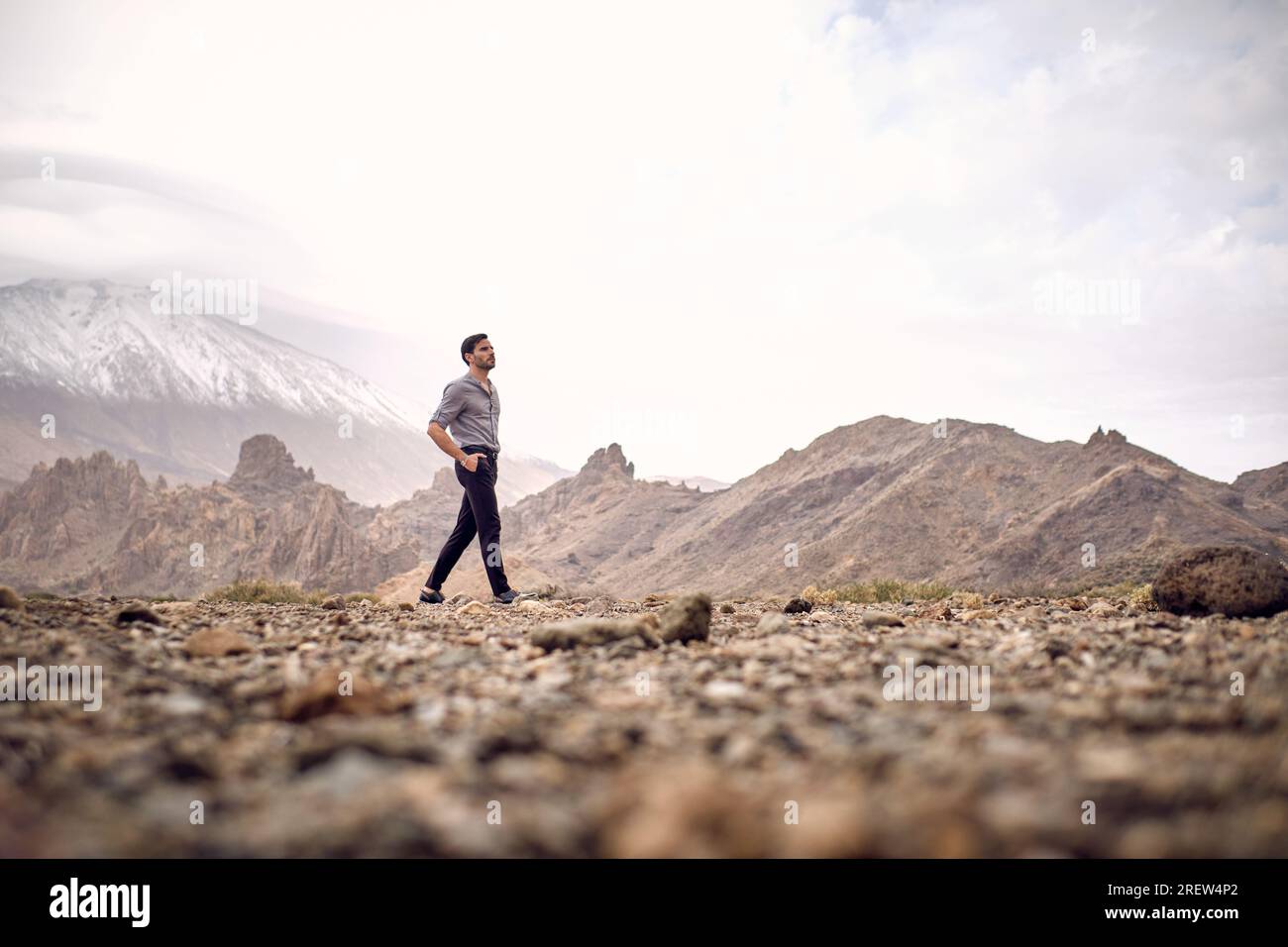 Side view full body ground level of bearded Hispanic male traveler ...
