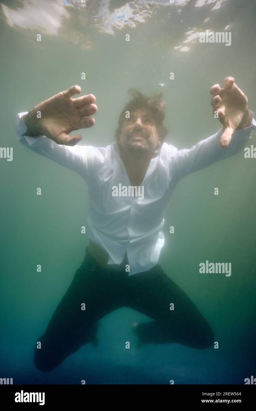 Man underwater clothes hi-res stock photography and images - Alamy