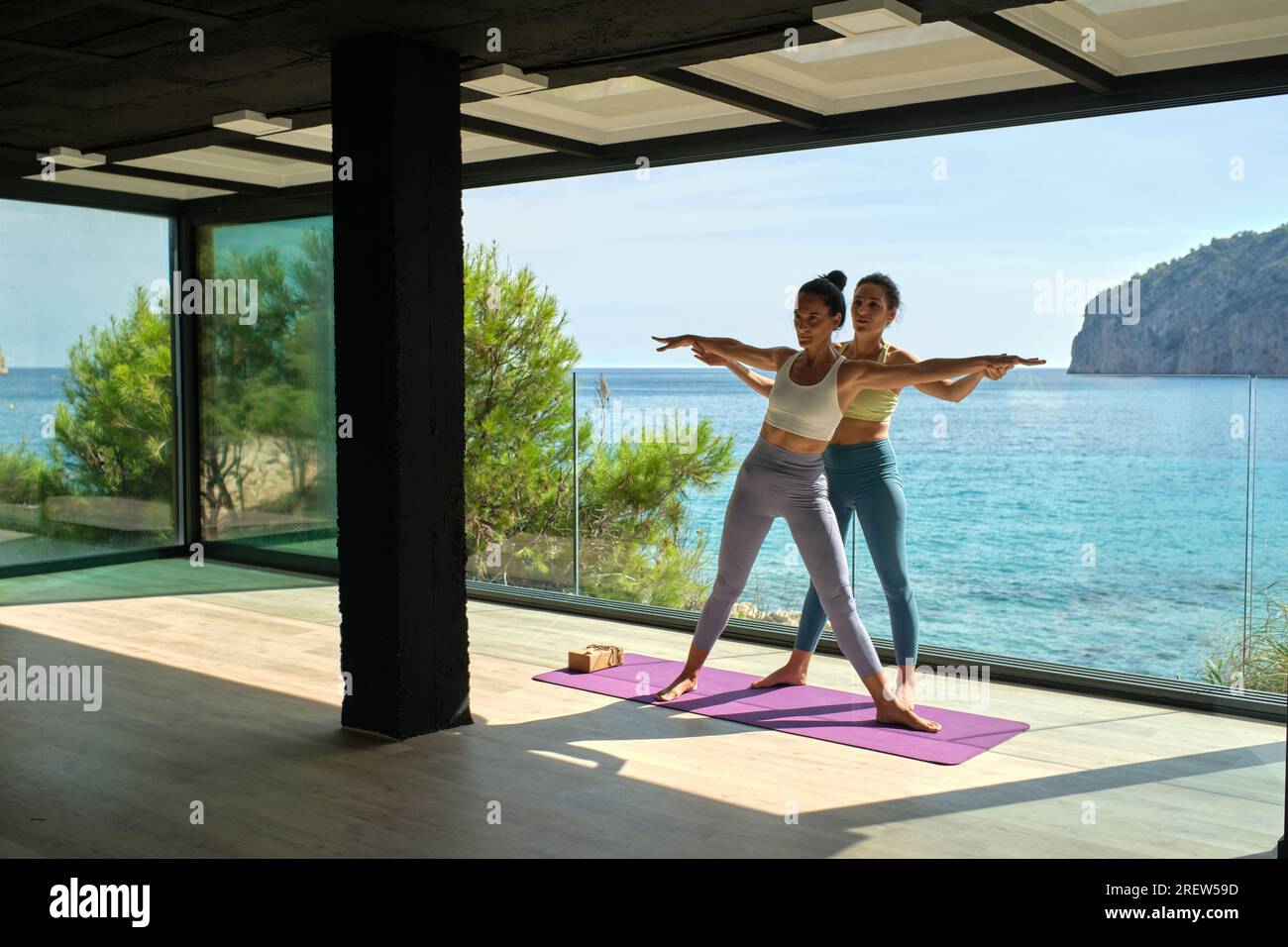 Full body of slim barefoot female doing side bend in Utthita Tadasana ...