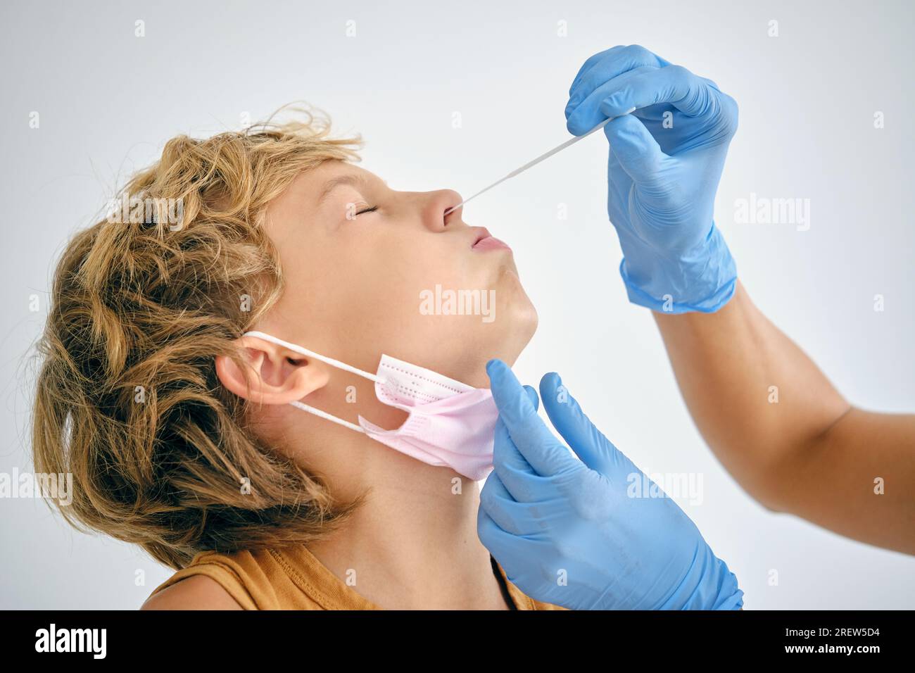 Crop unrecognizable medic with swab taking coronavirus test from nose ...
